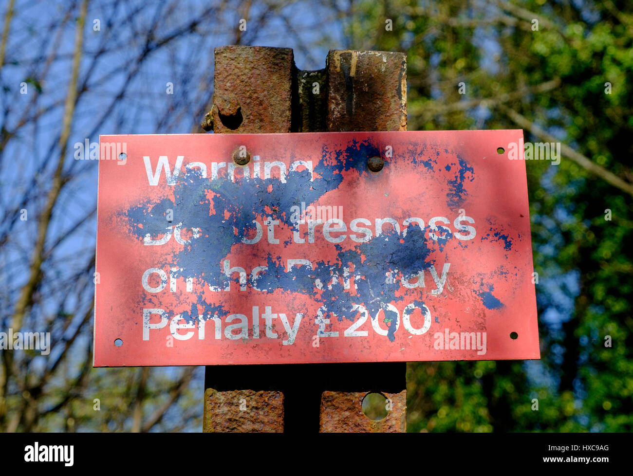 Red Railway trespass warning sign splattered with paint pictured in ...