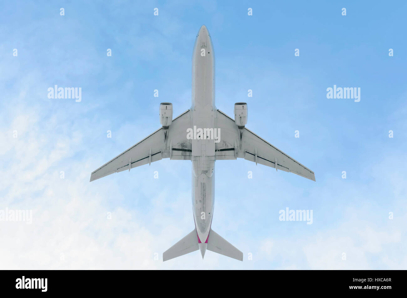 Bottom view of a fully white plane, of an unrecognized commercial ...