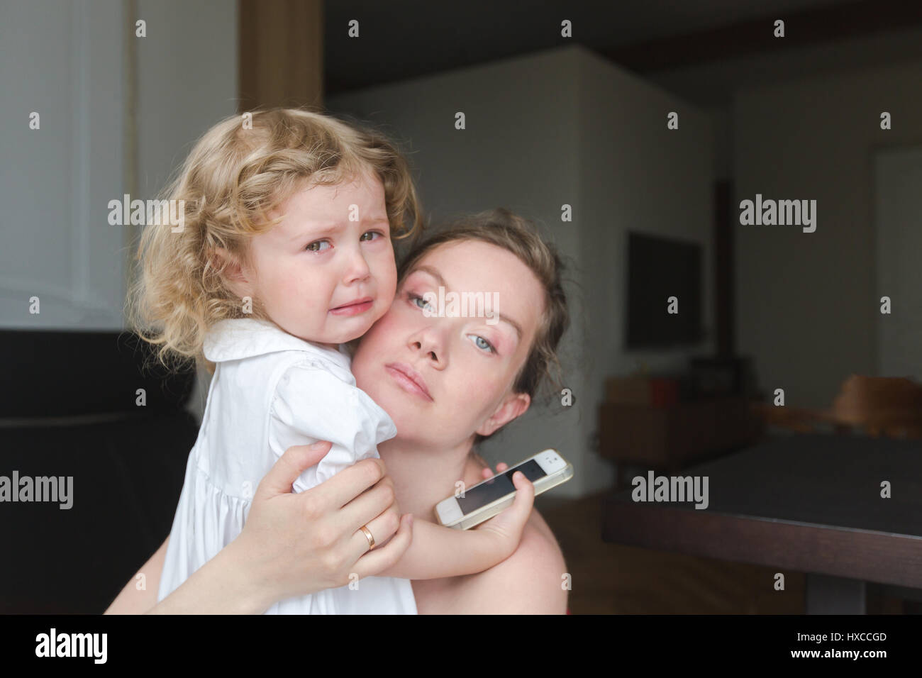 Woman embracing sad girl Stock Photo - Alamy