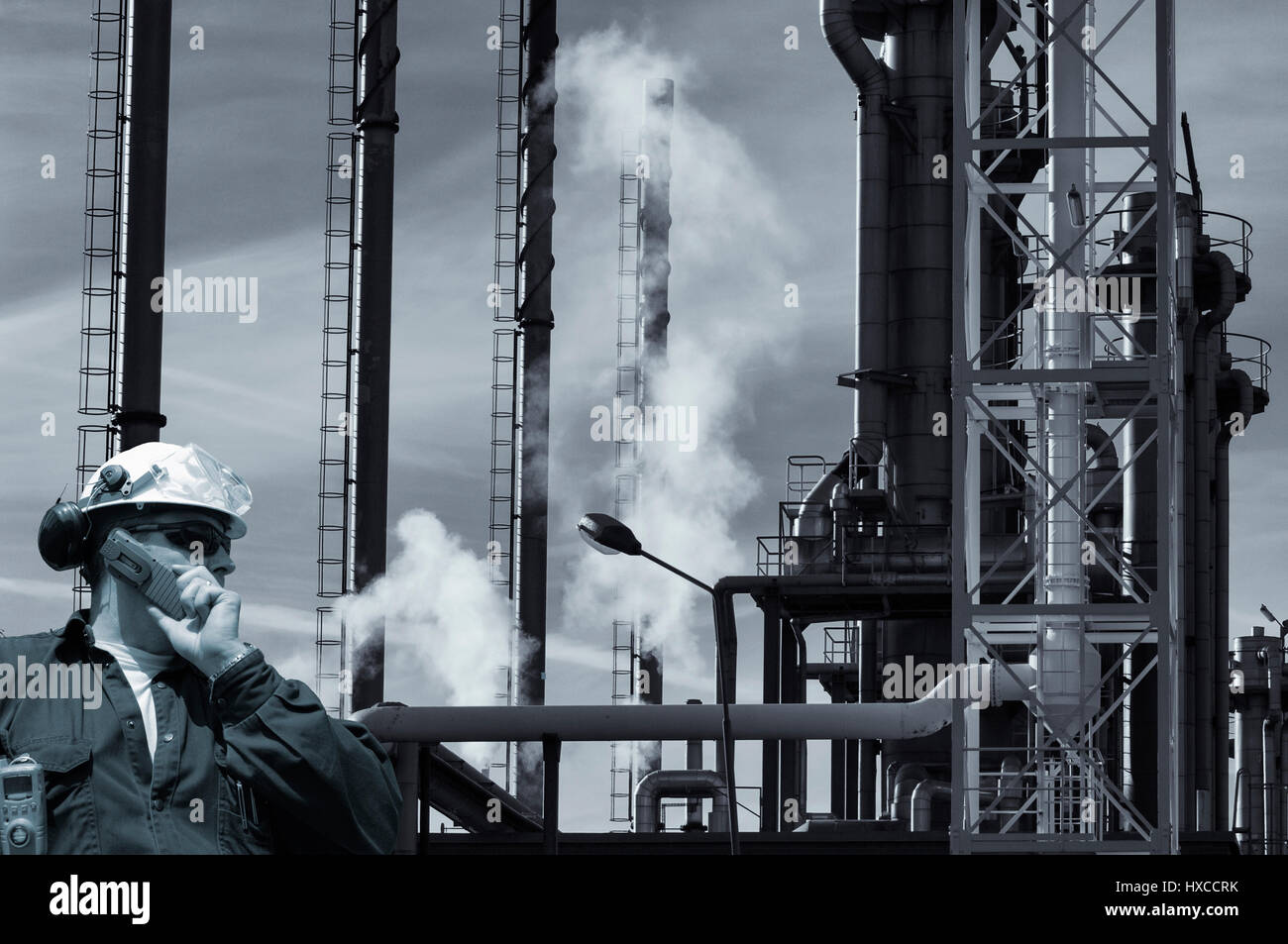 refinery worker with petrochemical industry, smoke and smog Stock Photo ...