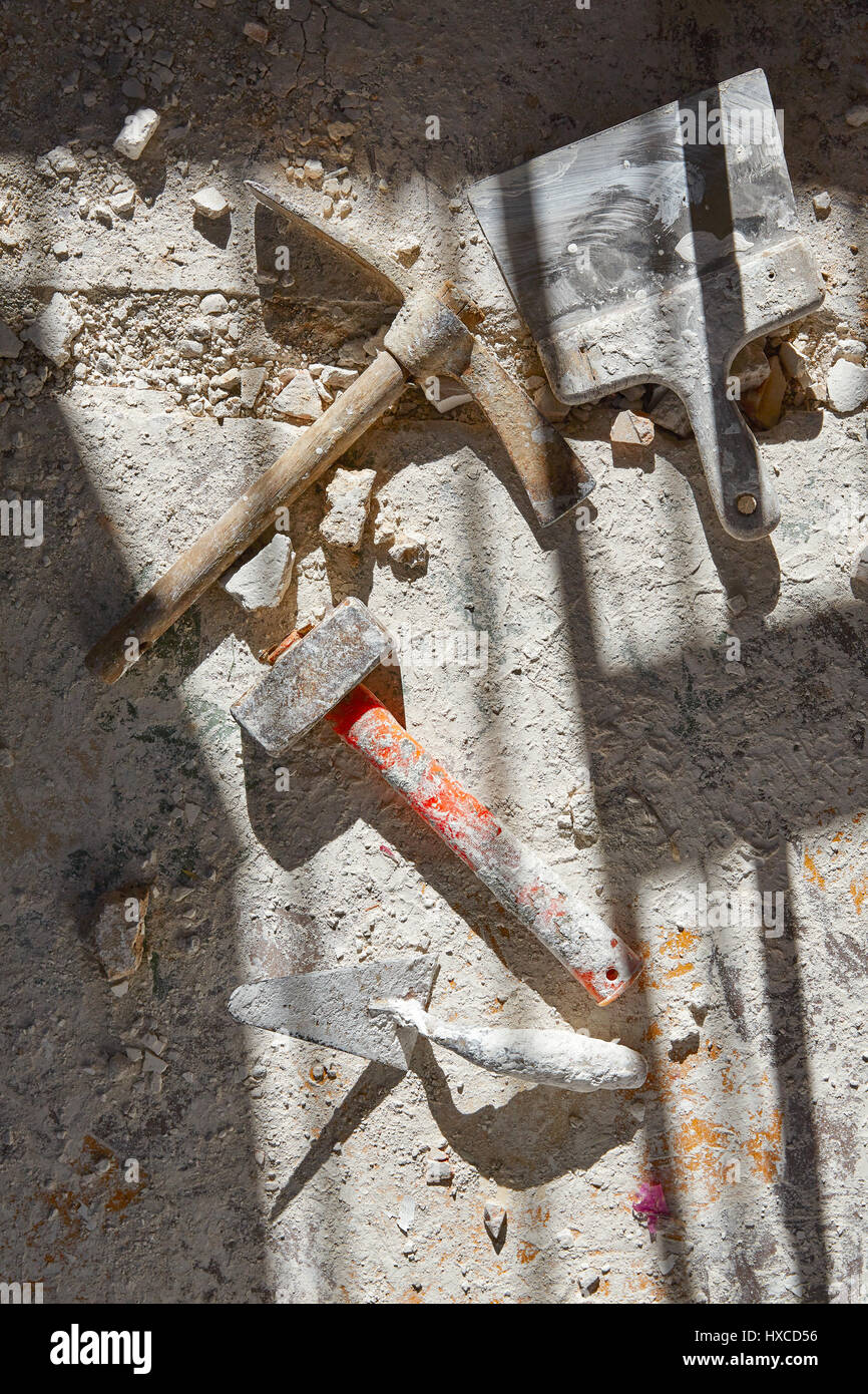 Mason tools on debris background in house improvement construction ...