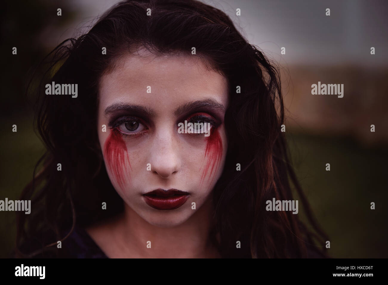 Halloween kid girl custome with bloody makeup on backyard turf Stock ...