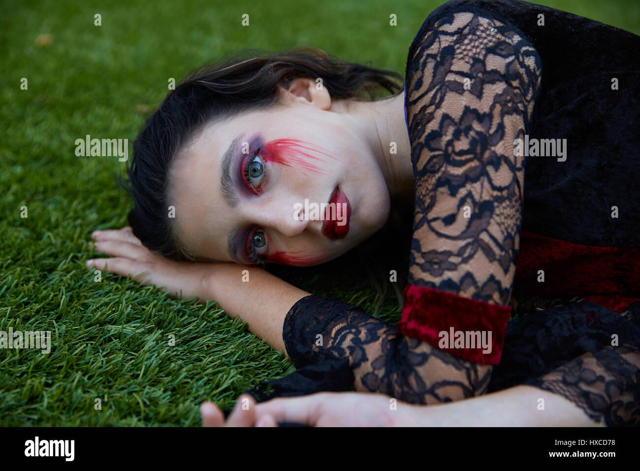 Halloween kid girl custome with bloody makeup on backyard turf Stock ...