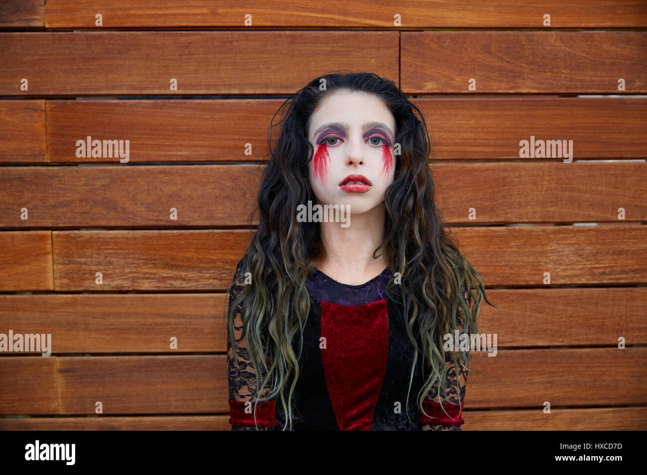Halloween kid girl custome with bloody makeup on wooden wall Stock ...