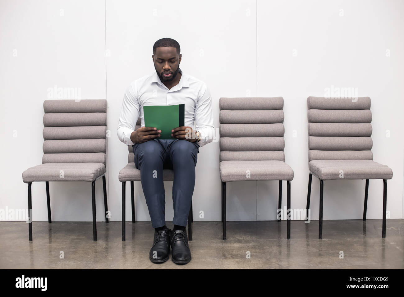 Young man sitting interview hi-res stock photography and images - Alamy