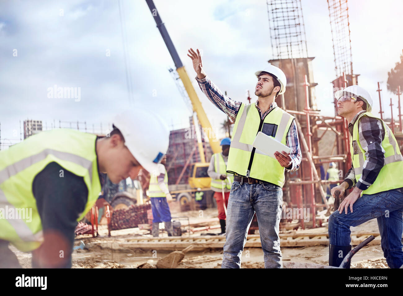 Construction workers talking at construction site Stock Photo - Alamy