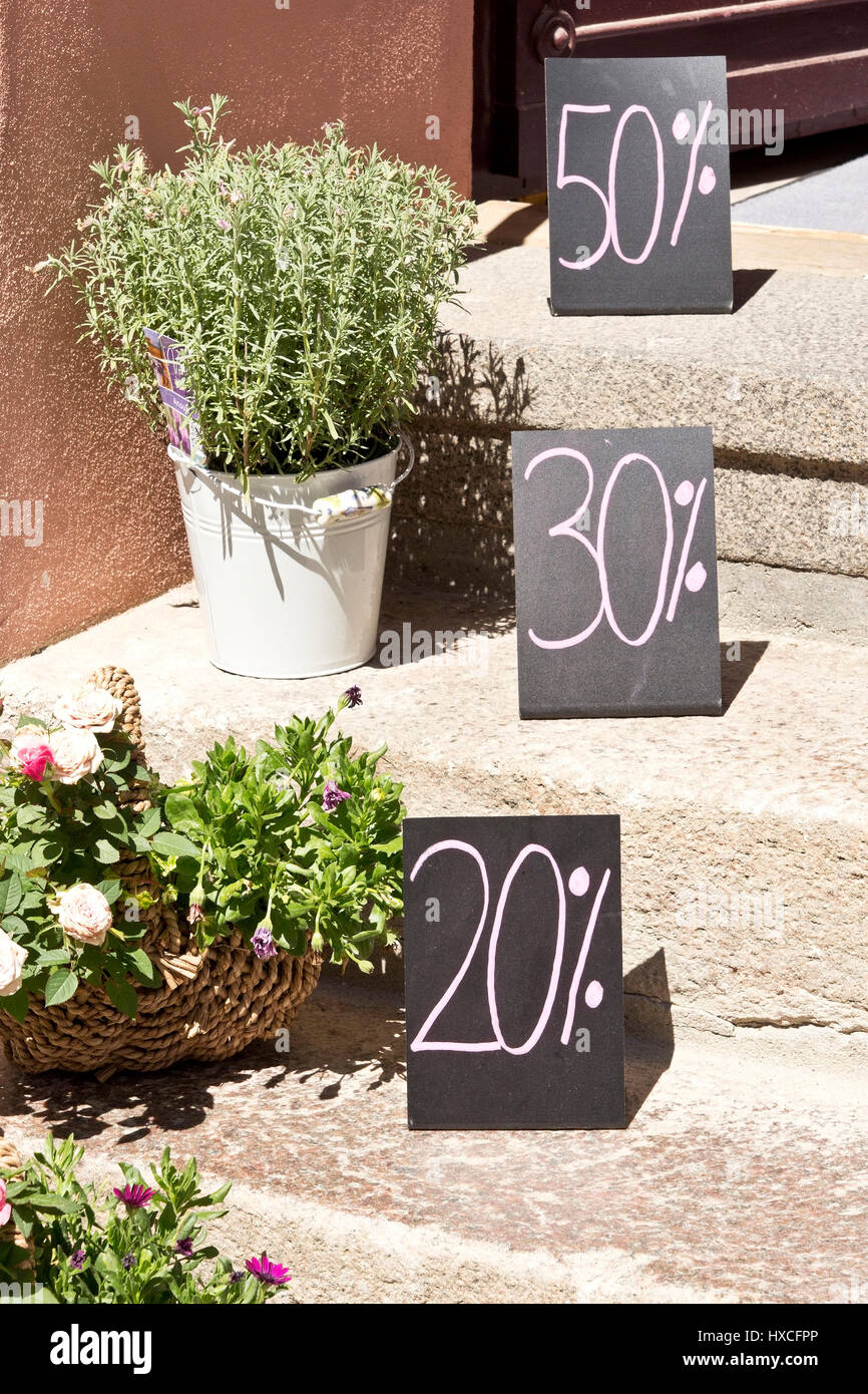 Discount signs on the stairway steps before a business in the shopping ...