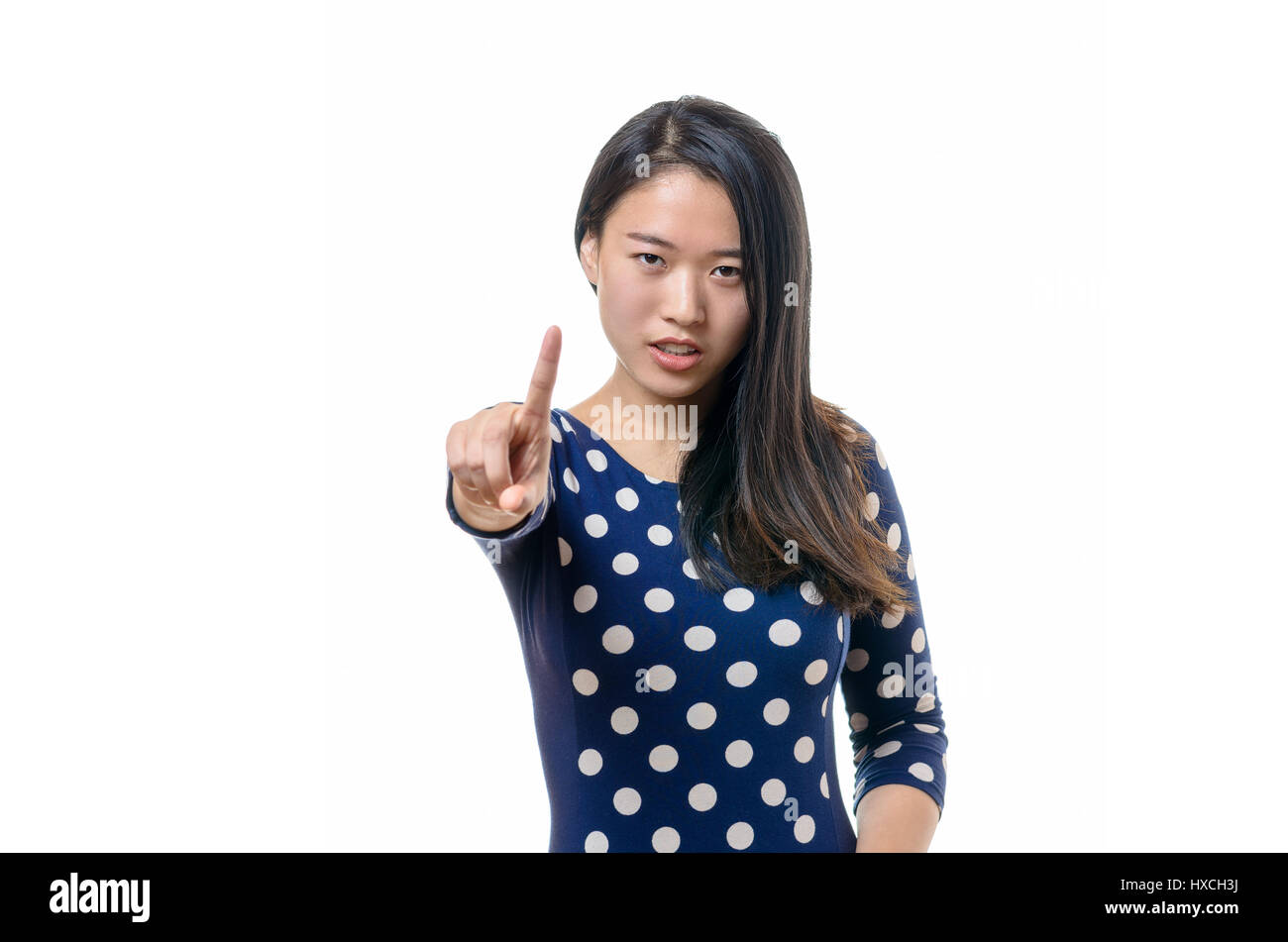 Angry stern young Chinese woman making a halt, enough or go away ...