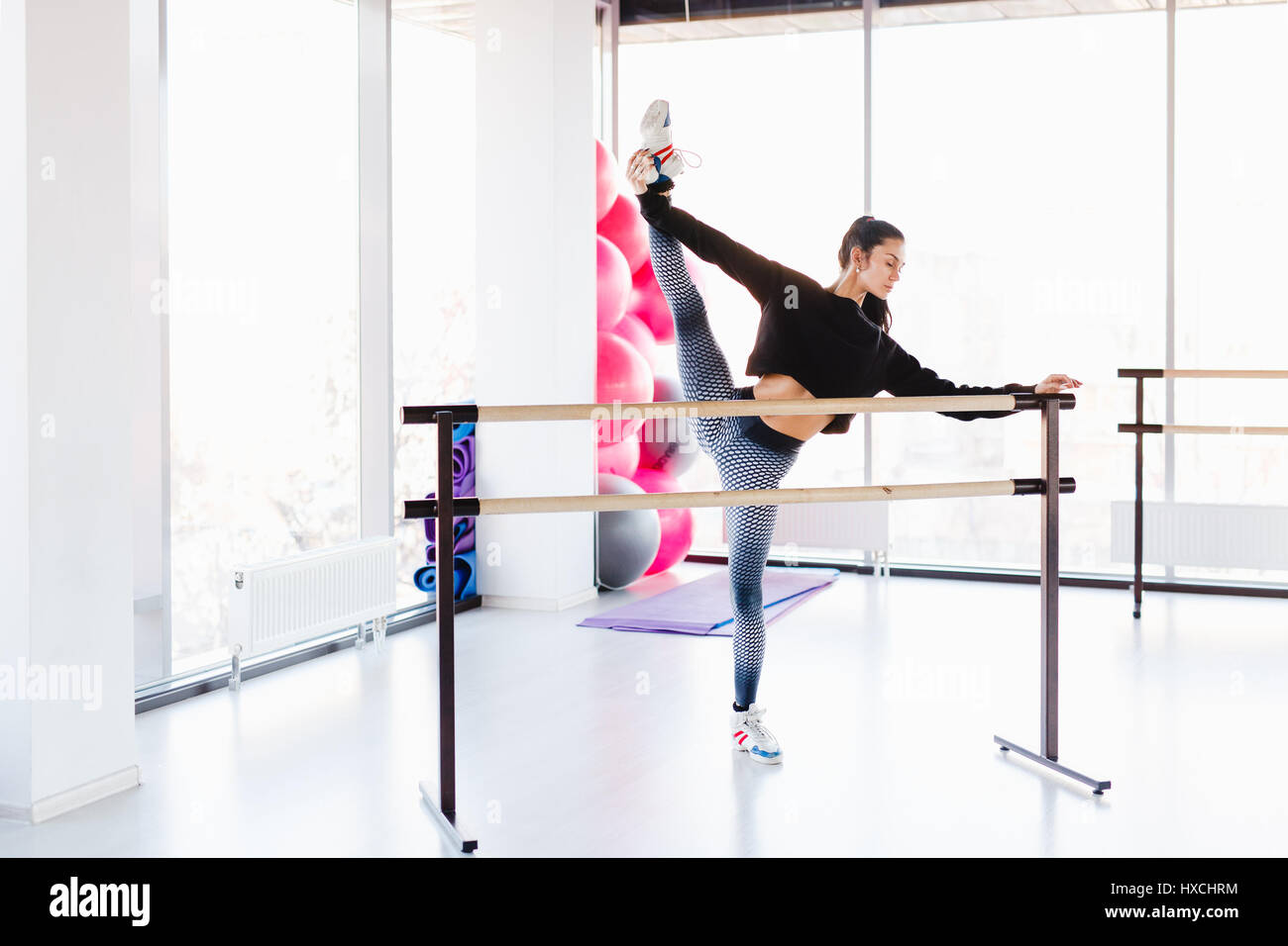 Young women doing stretching exercises on yhe bars in the aerobics ...