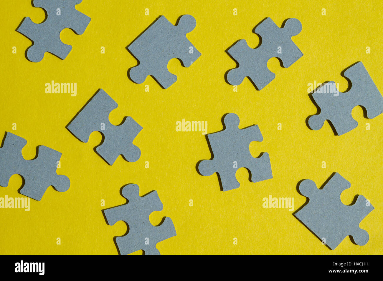 Jigsaw Puzzle pieces on yellow background horizontal with copy space ...