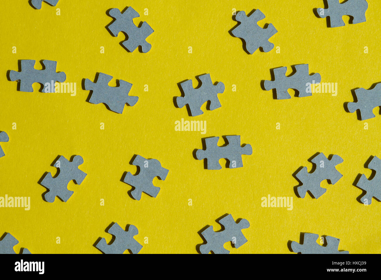 Jigsaw Puzzle pieces on yellow background horizontal view Stock Photo ...