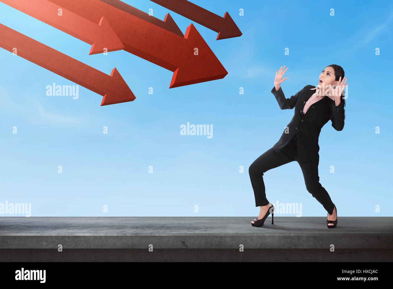 Shocked asian business woman with red arrow going down to her on the ...