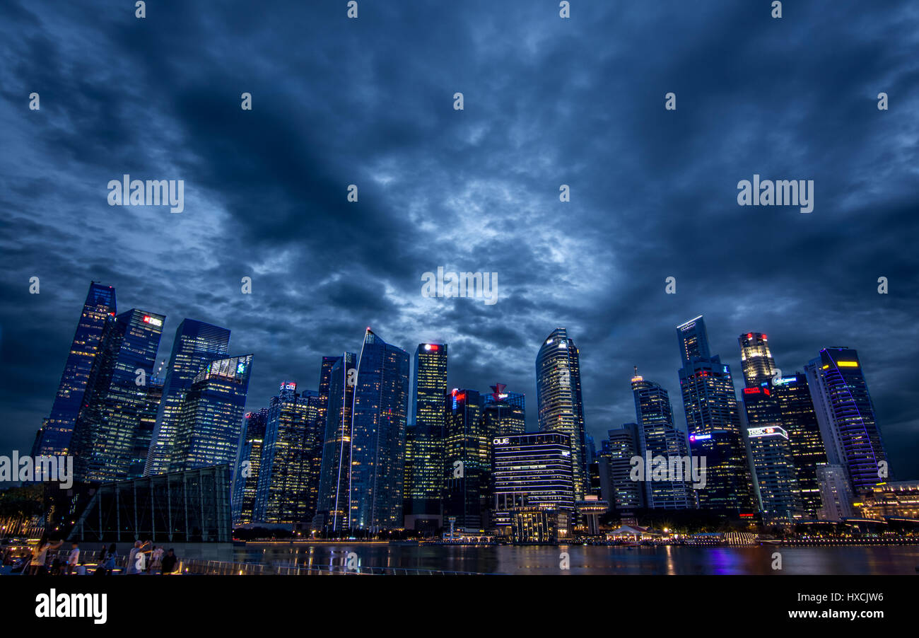 Moon light shinning through clouds over the city scape of Singapore ...