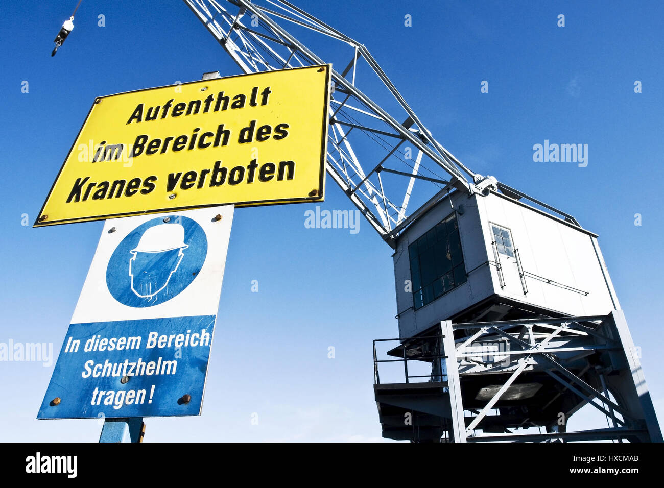 Warning and old crane, Warnschild und alter Kran Stock Photo - Alamy