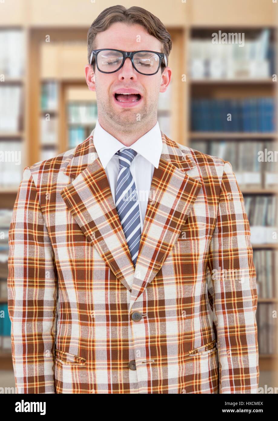 Digital composite of Nerd man crying against library bookshelves Stock ...