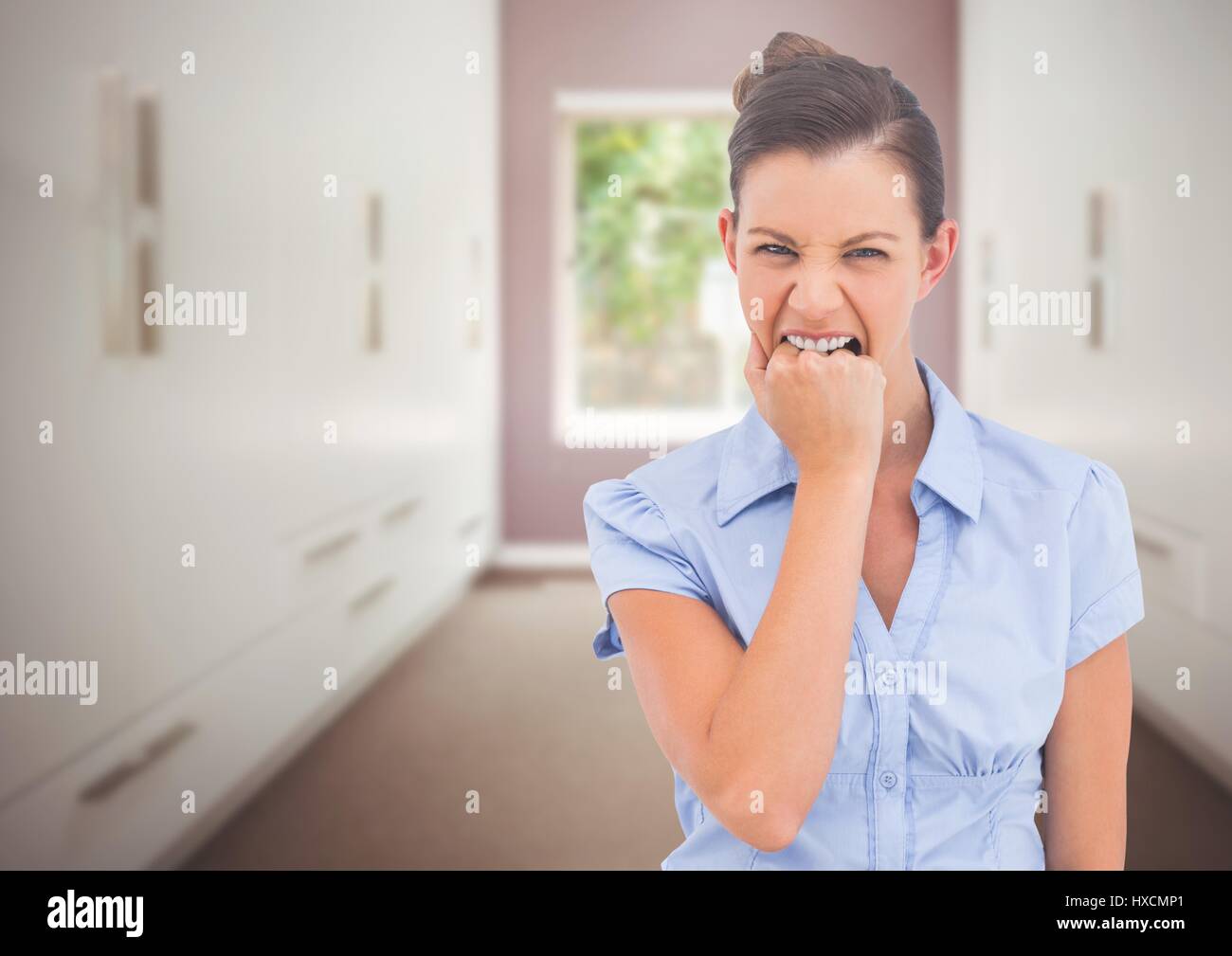 Digital composite of Stressed woman biting hand in room Stock Photo - Alamy