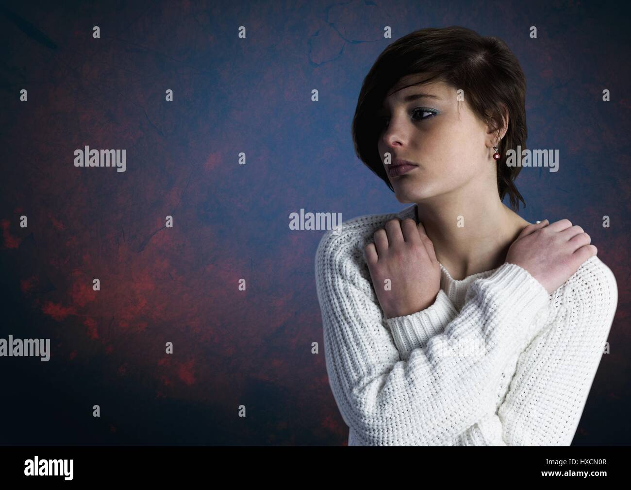 Digital composite of Sad young woman grief against blue background ...