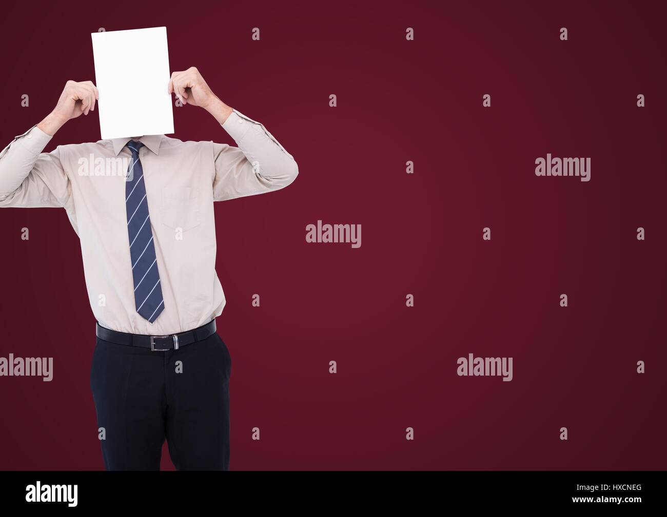 Digital composite of Business man with blank card over face against ...