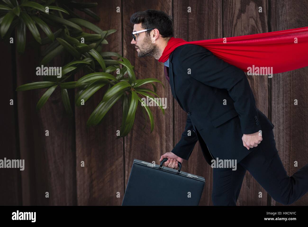 Digital composite of Confident business man super hero walking against ...