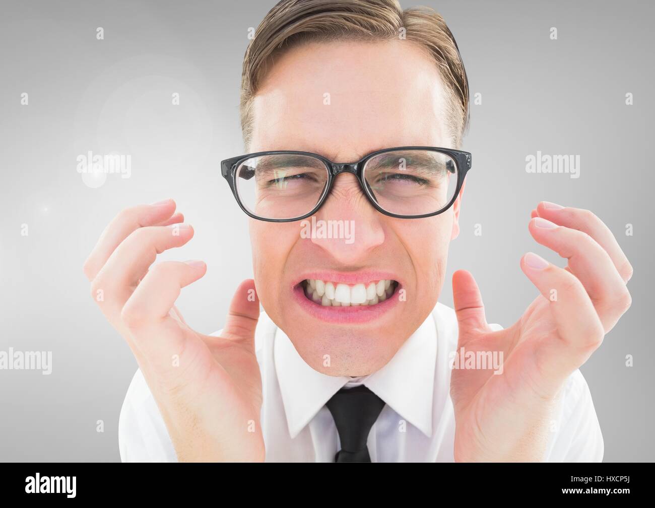 Stressed businessman gesturing against bright white room with windows ...
