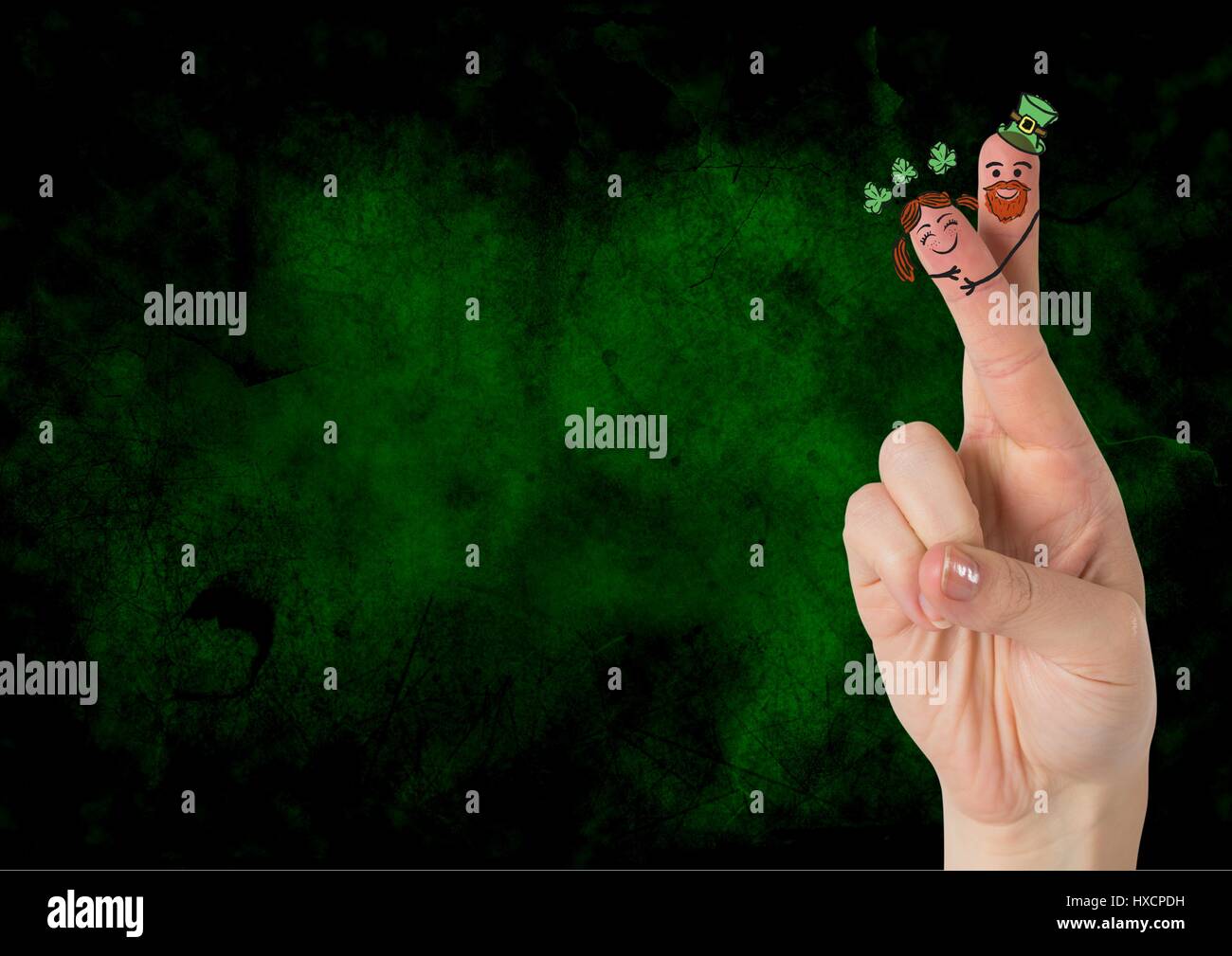Digital composite of Patrick's Day fingers crossed against dark green ...