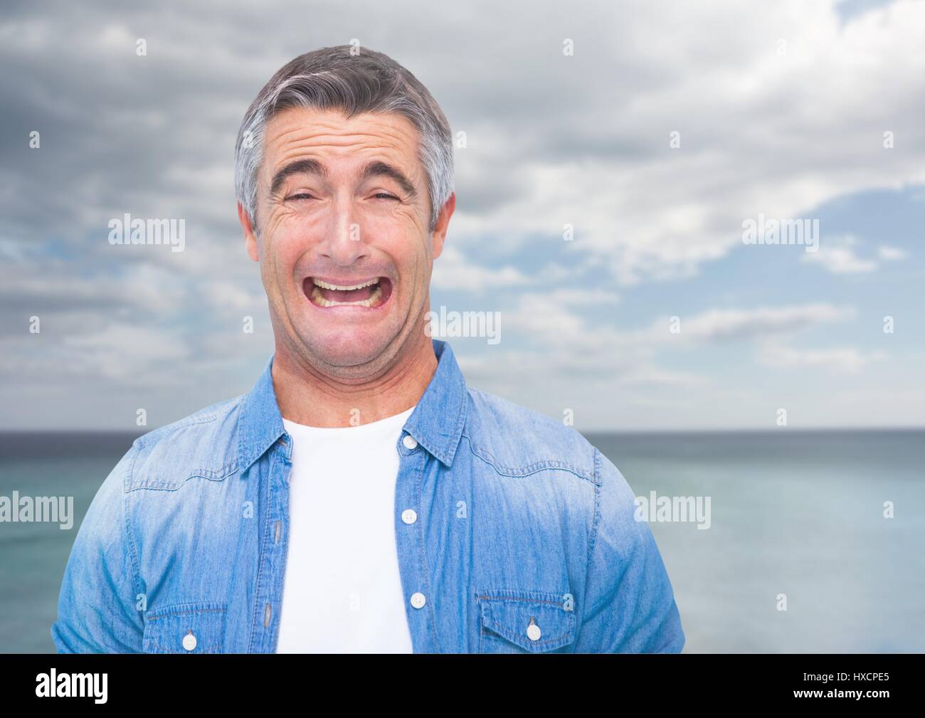Digital composite of Man crying against sea Stock Photo - Alamy