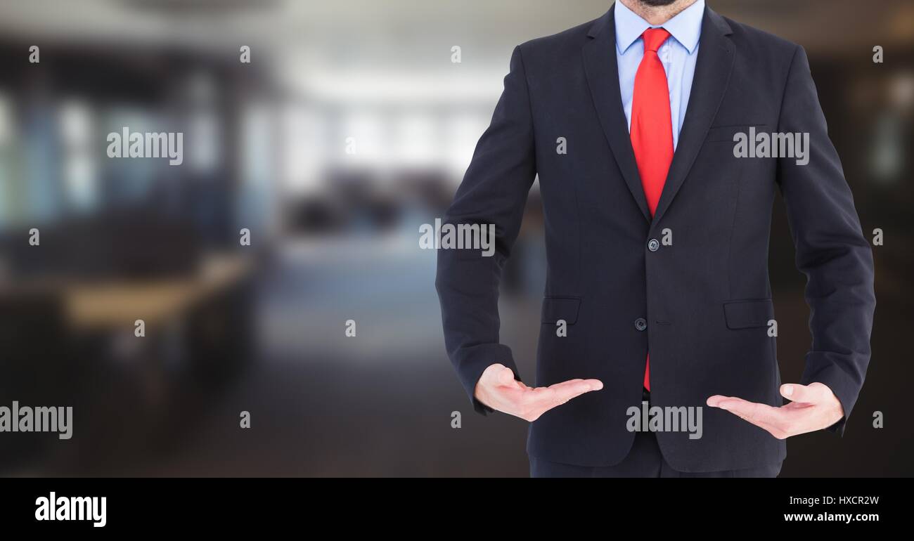 Digital composite of Business man mid section with palms up in blurry ...