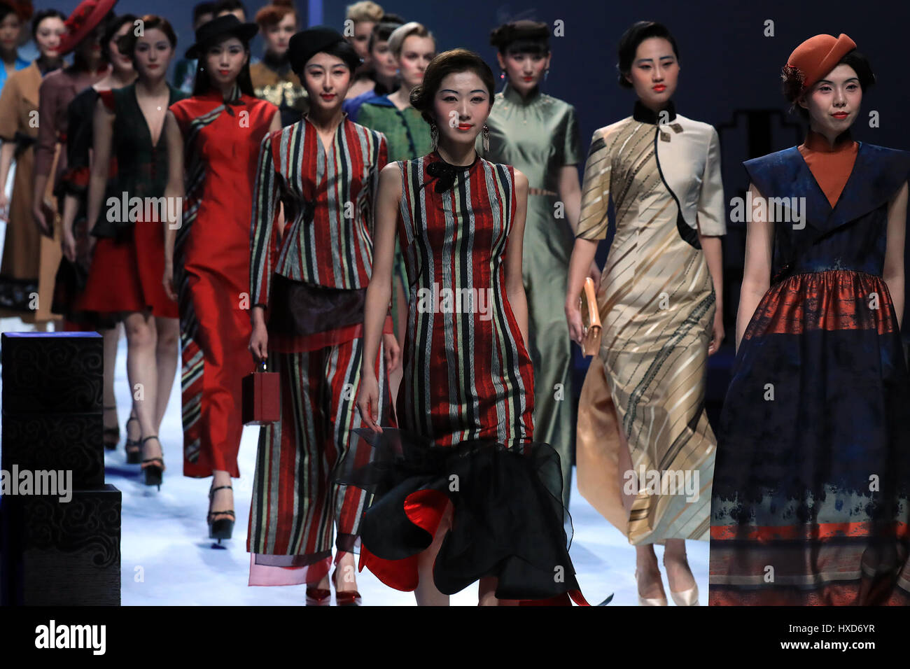 Beijing, China. 28th Mar, 2017. Models present creations designed by ...