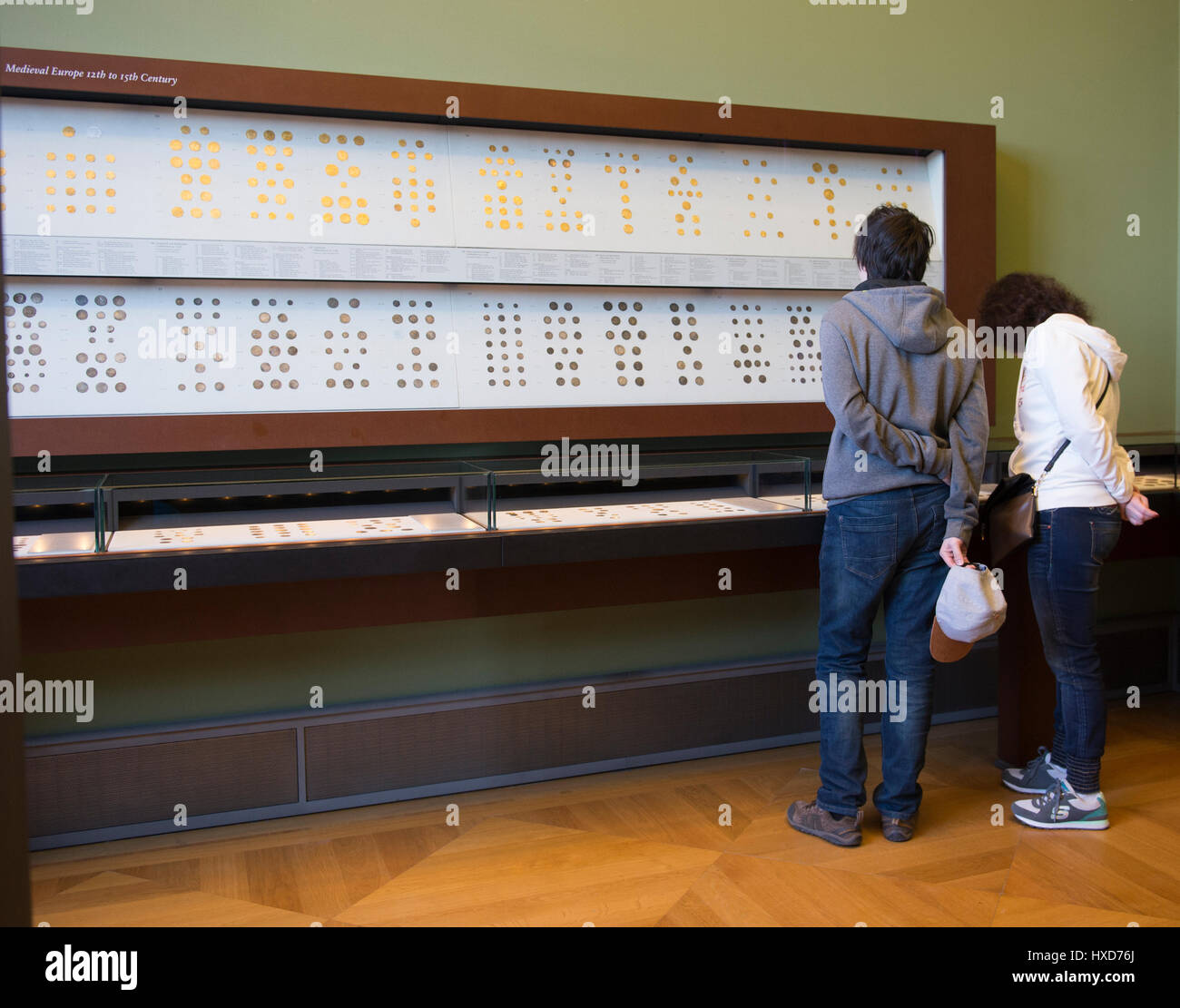 Visitors look at coins in a display cabinet where the million dollar ...