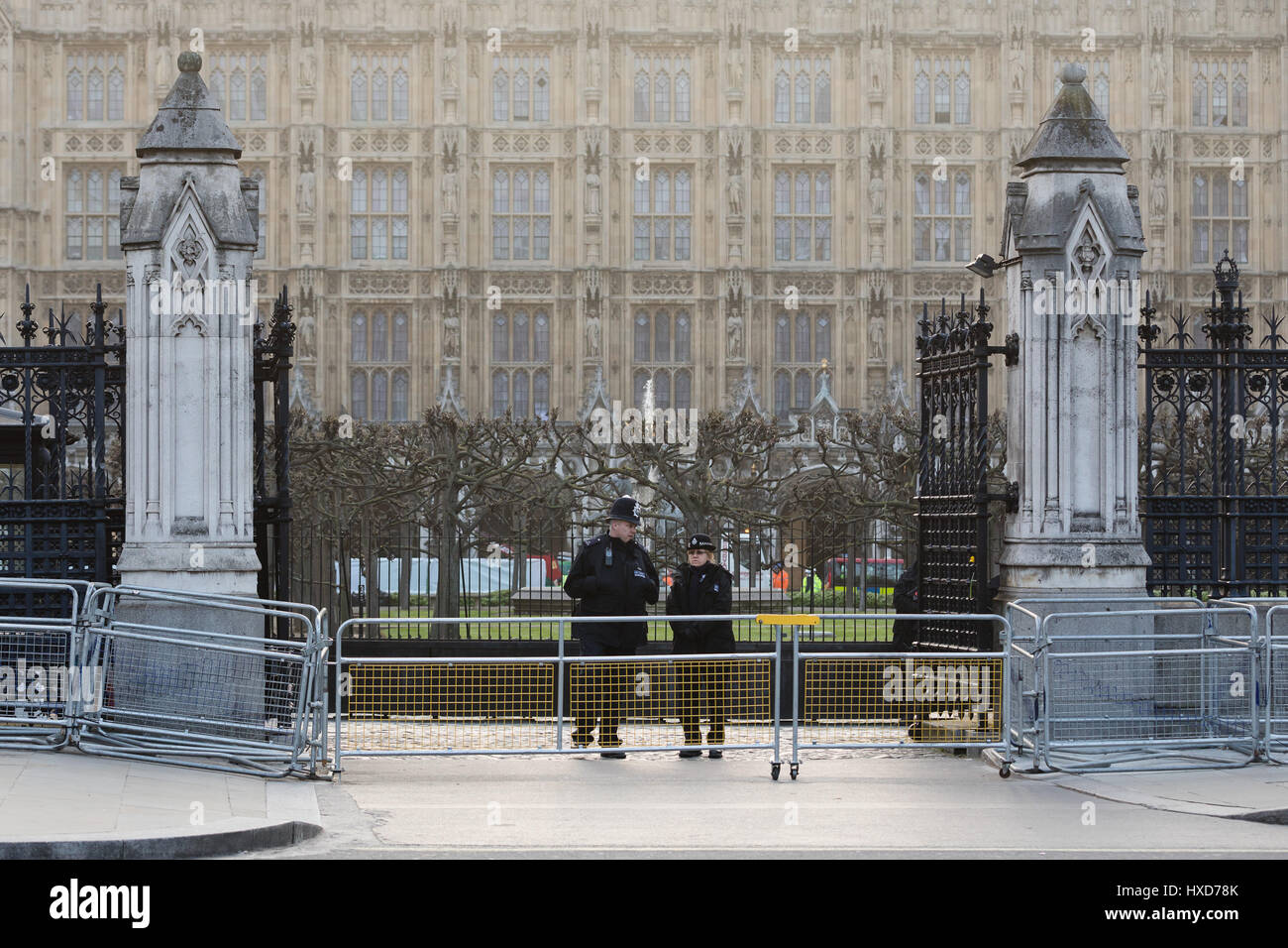 London, UK. 28th March 2017. Unarmed police officers stand at the gates ...