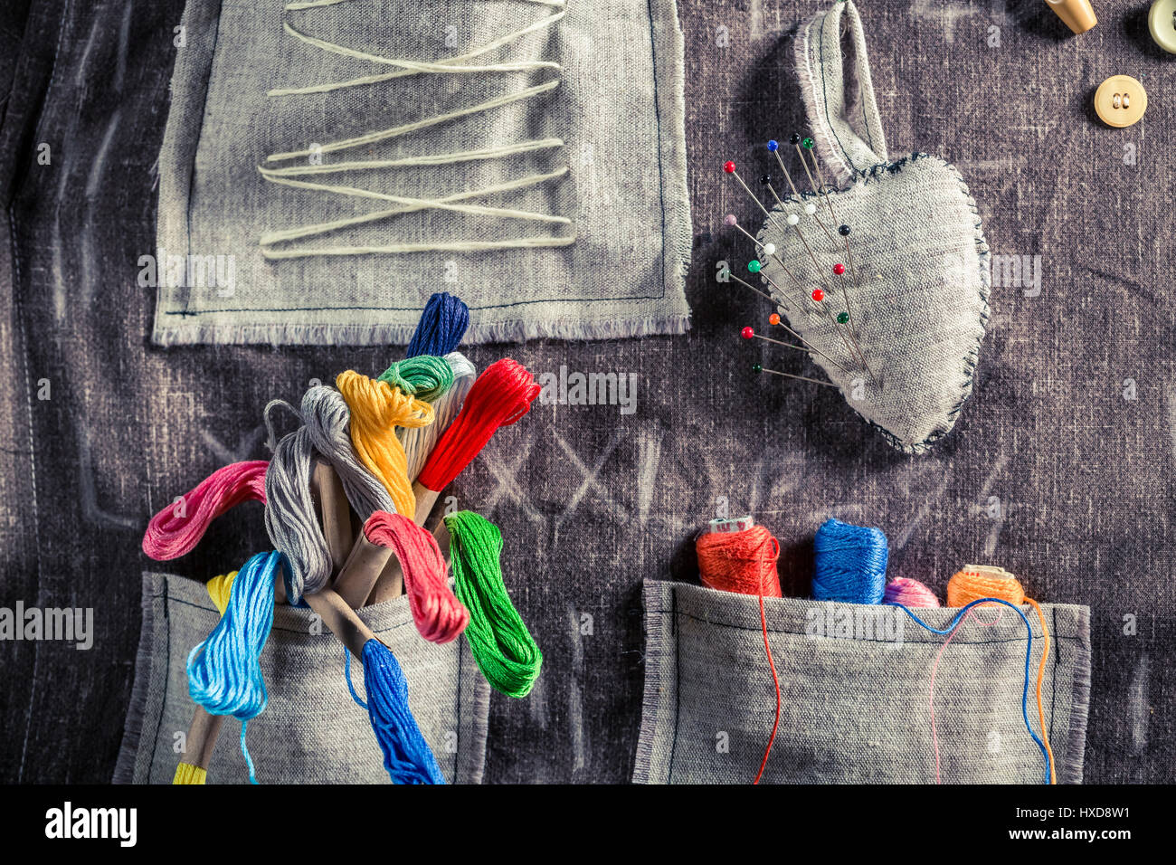 Handmade sewing cloth with scissors, needles and threads in tailor ...