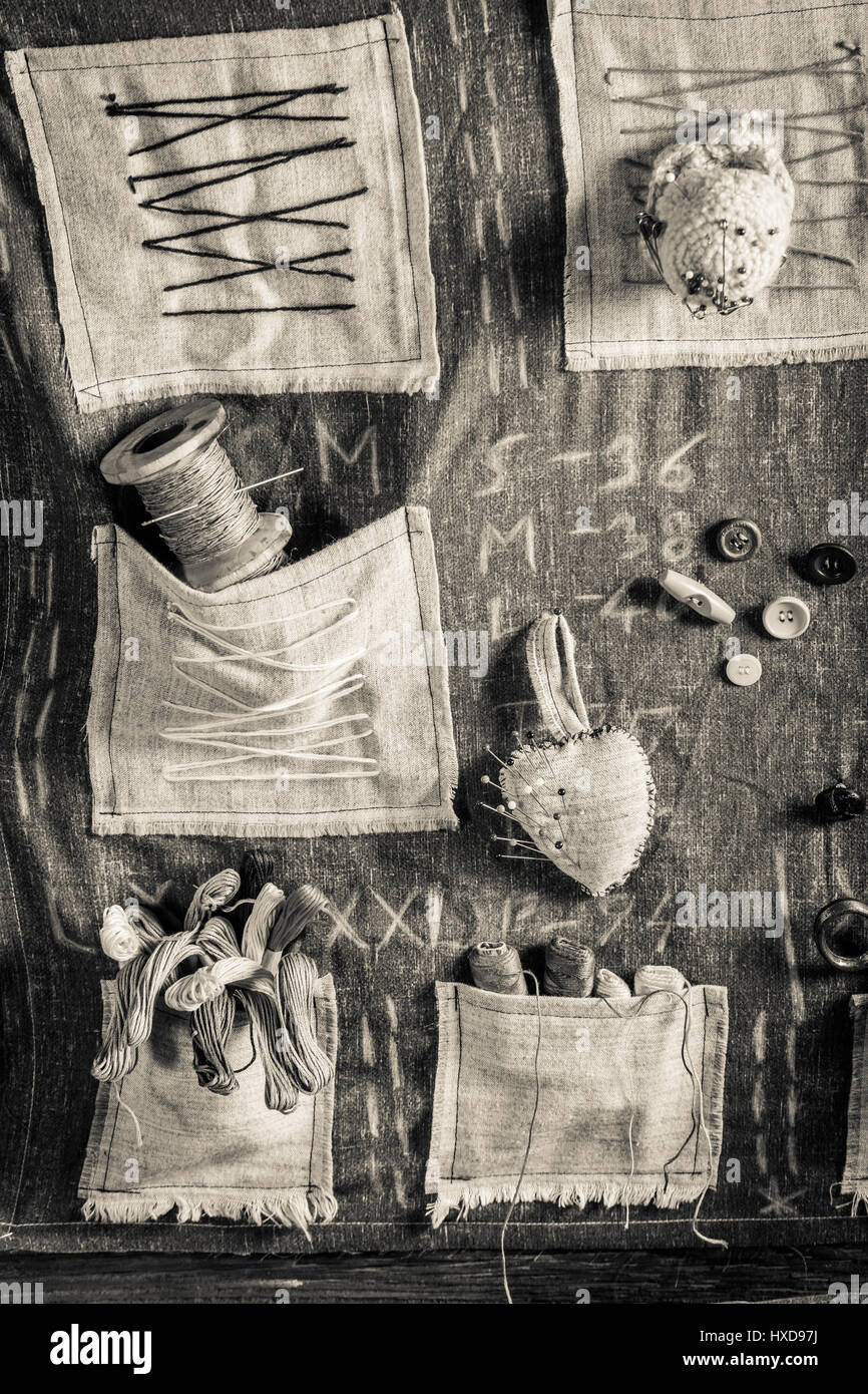 Old sewing cloth made of buttons, needles and threads in tailor ...