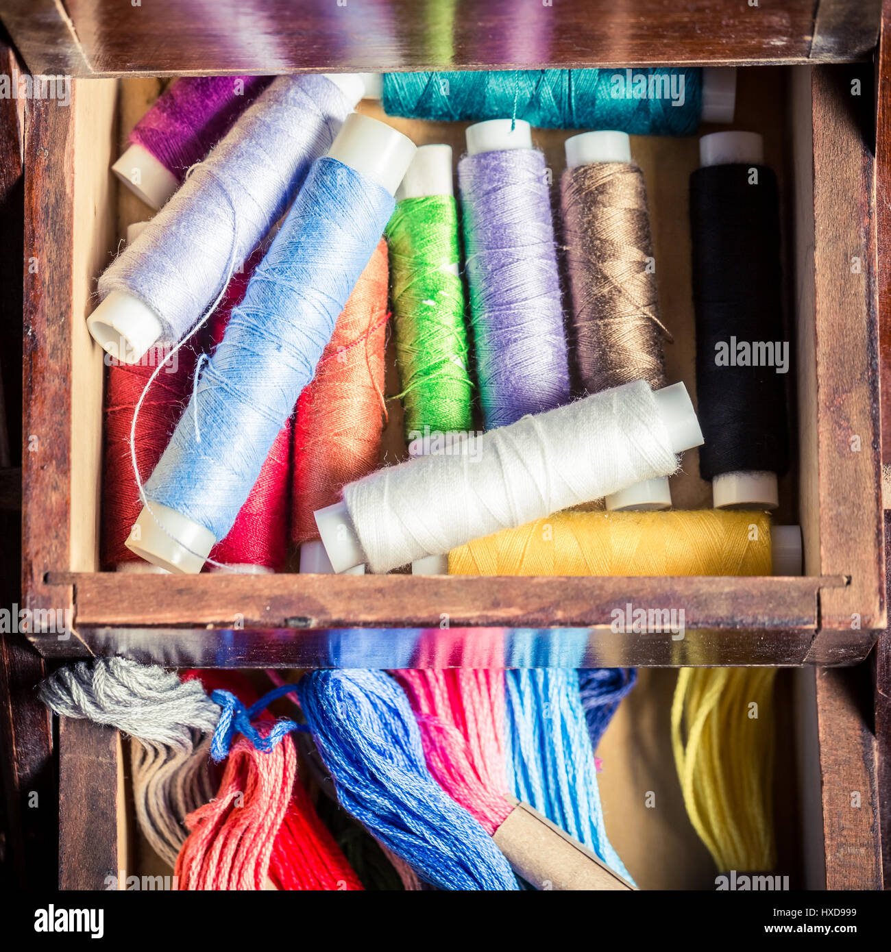 Closeup of tailor's wooden box with threads, needles and buttons Stock ...