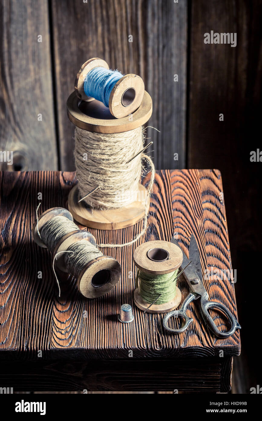 Sewing table with scissors and threads Stock Photo - Alamy