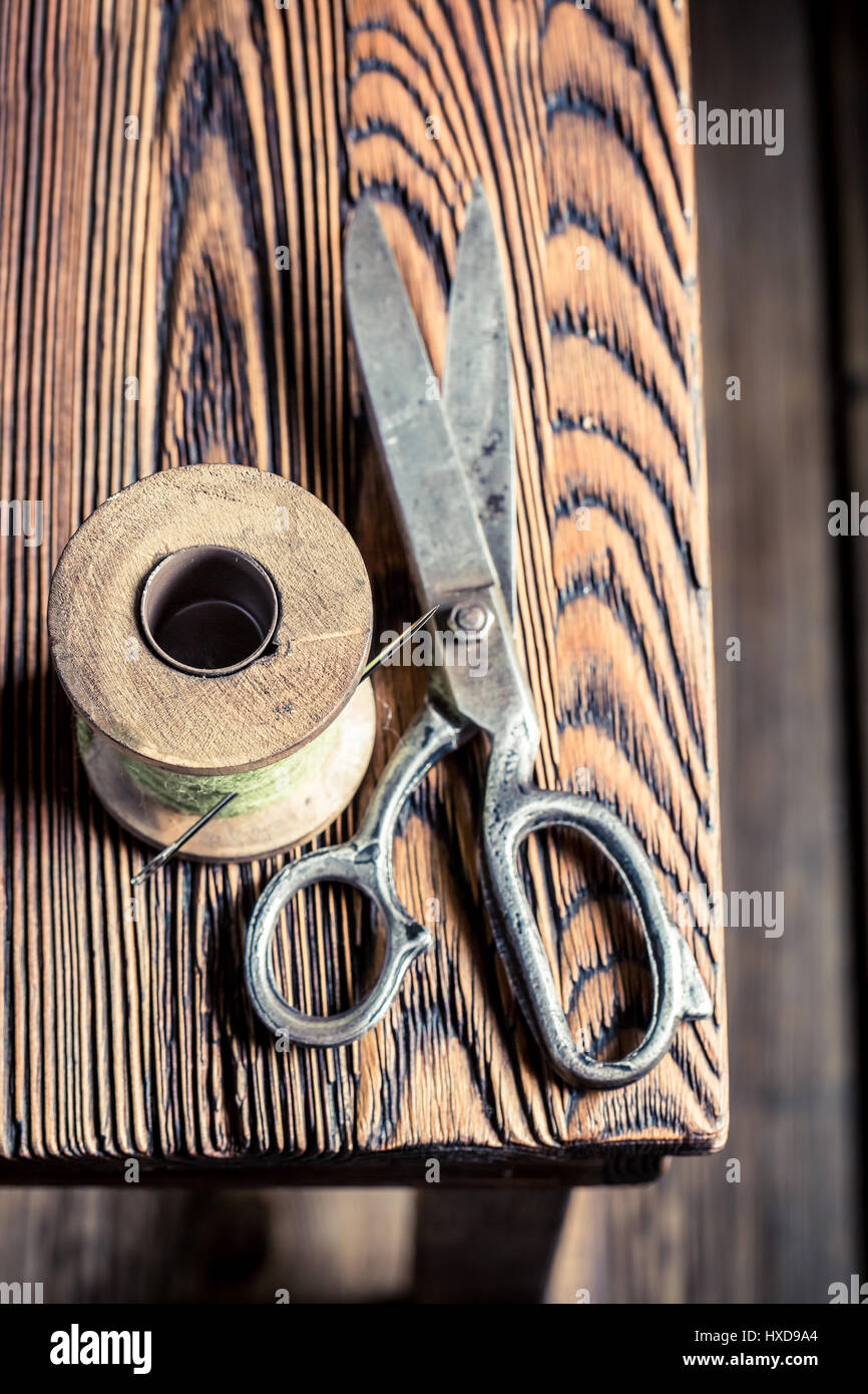 Vintage sewing table with scissors and threads Stock Photo - Alamy