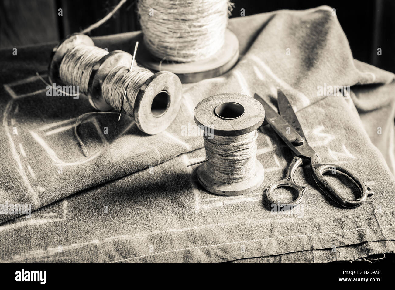 Vintage sewing table with threads, needle and scissors Stock Photo - Alamy