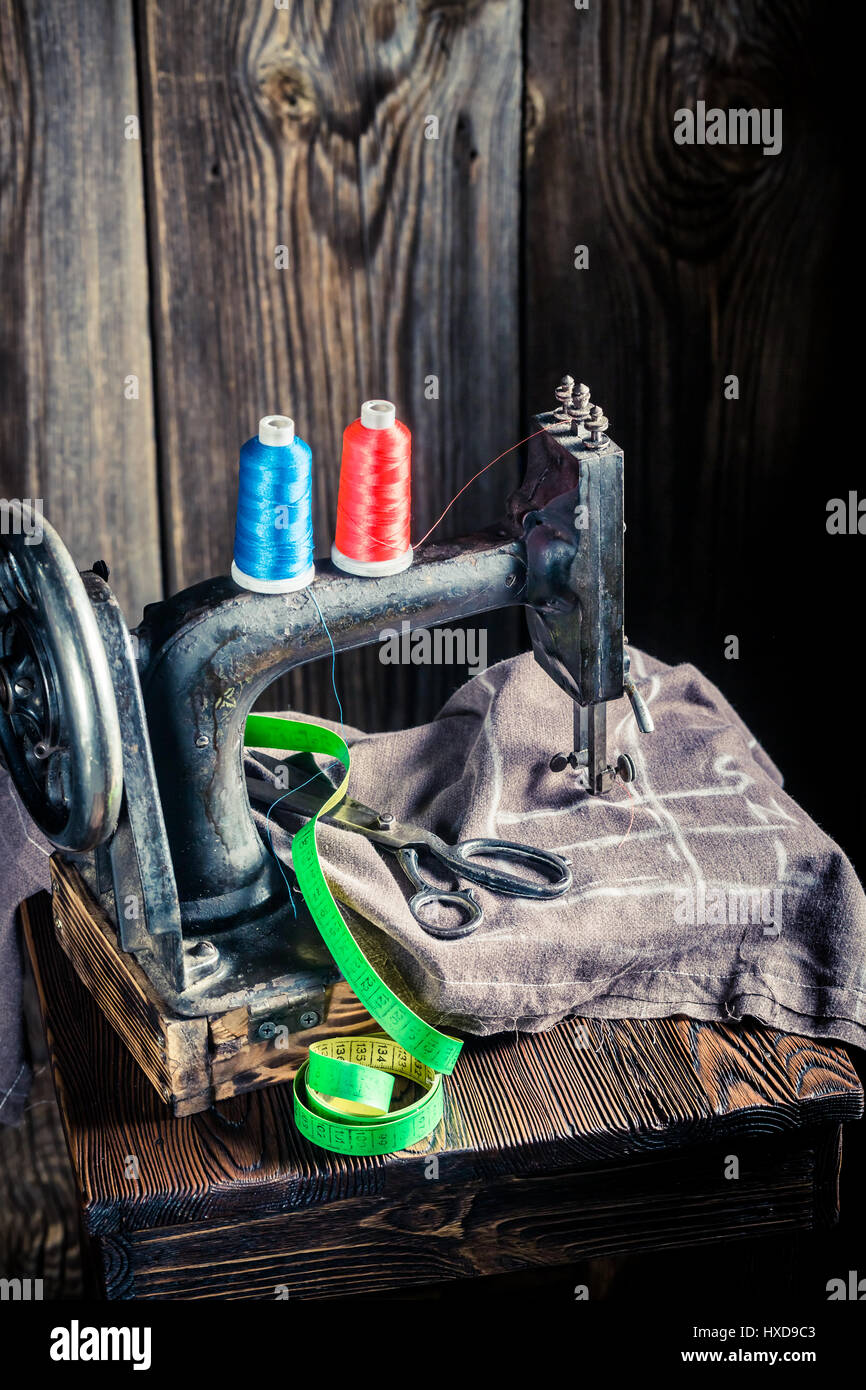 Sewing machine with scissors, threads and cloth Stock Photo - Alamy