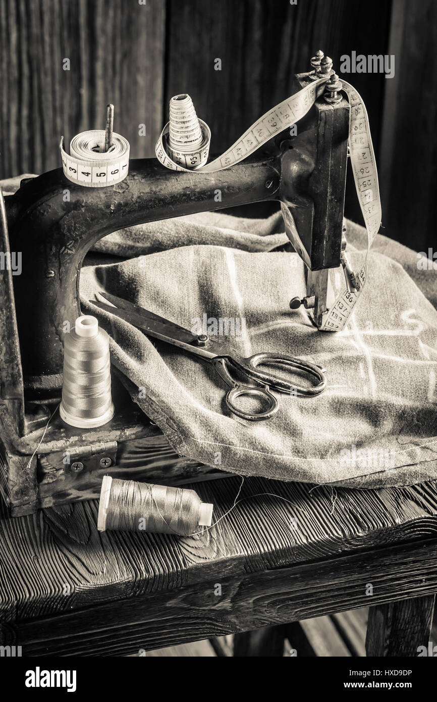Vintage sewing machine with scissors, threads and cloth Stock Photo - Alamy