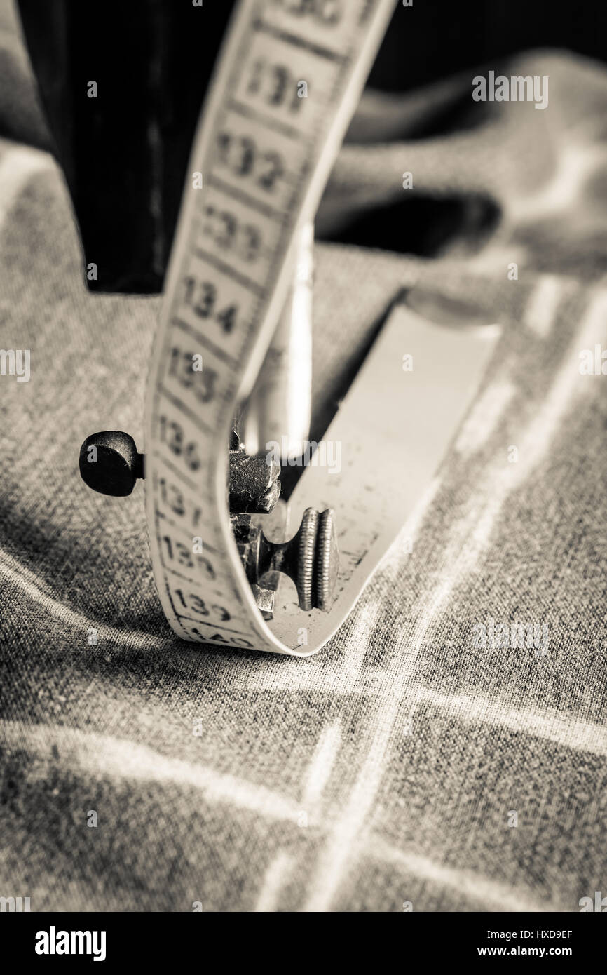 Vintage tailor machine with scissors, threads and cloth Stock Photo - Alamy