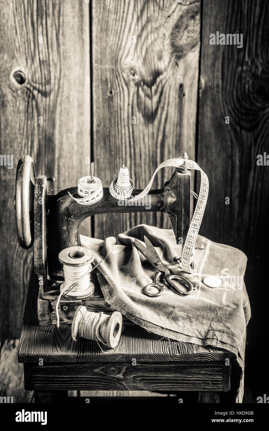 Old tailor machine with threads, scissors and cloth Stock Photo - Alamy