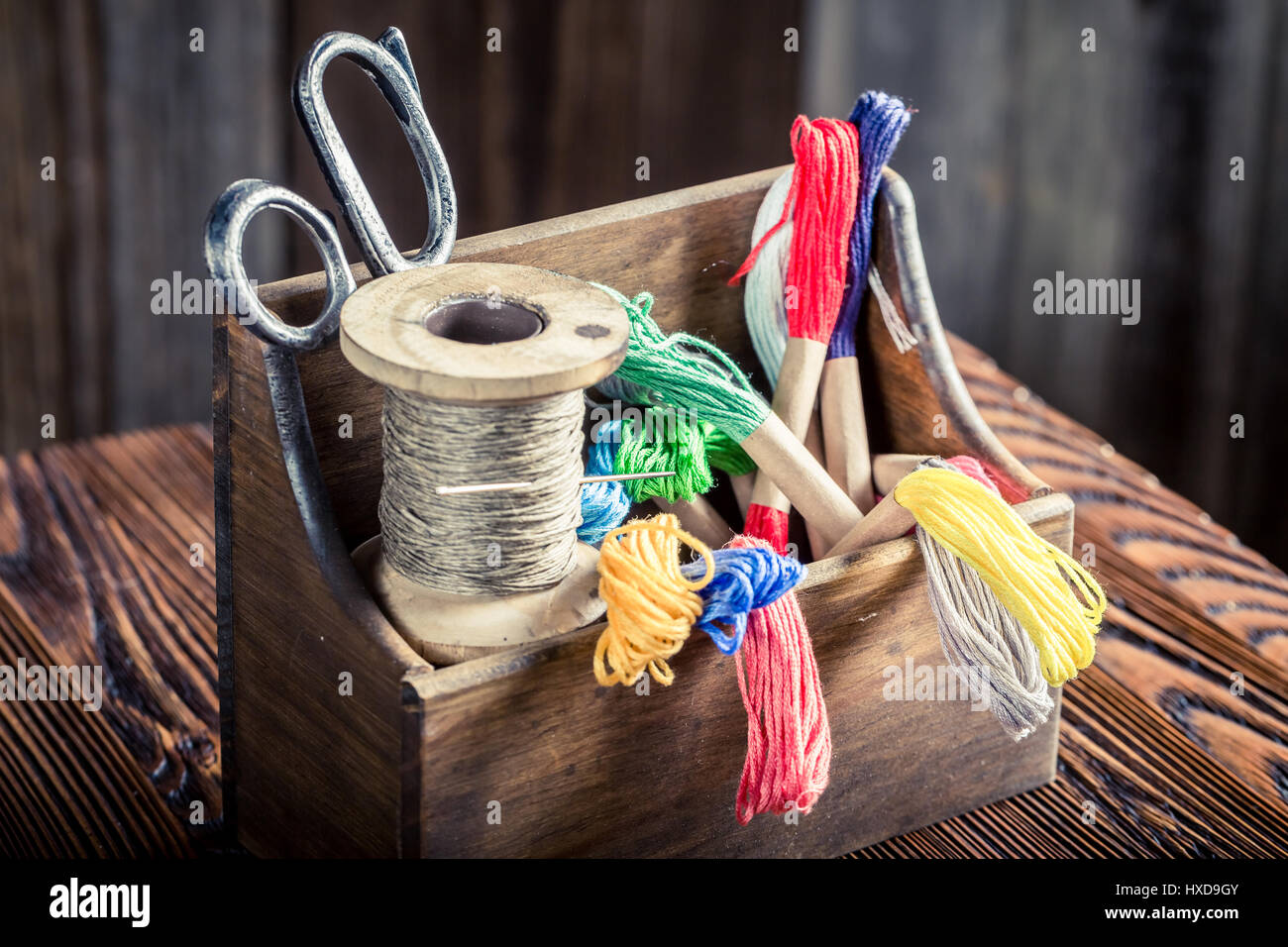 Needle, threads and scissors on tailor table Stock Photo - Alamy