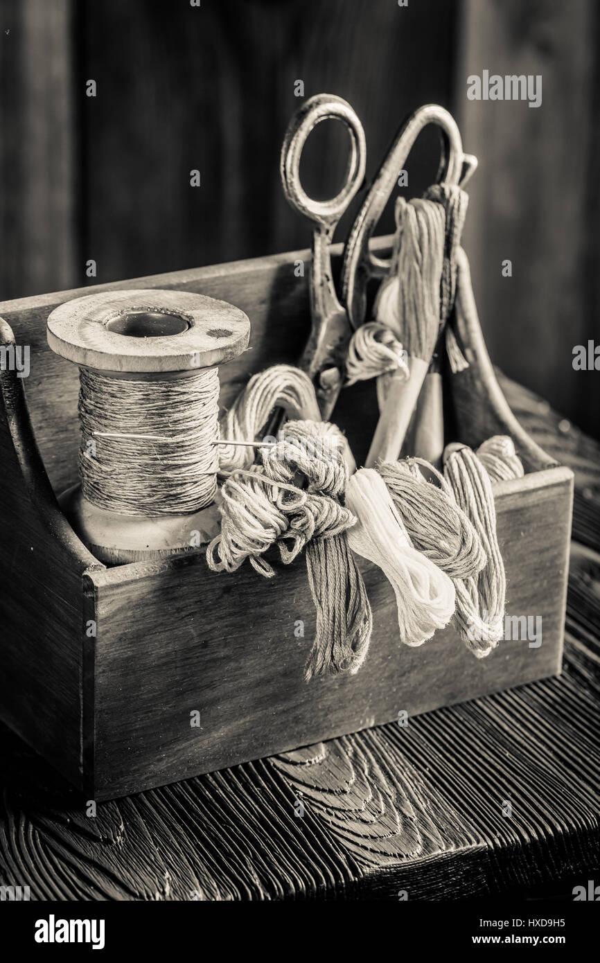 Needle, threads and scissors in tailor workshop Stock Photo - Alamy