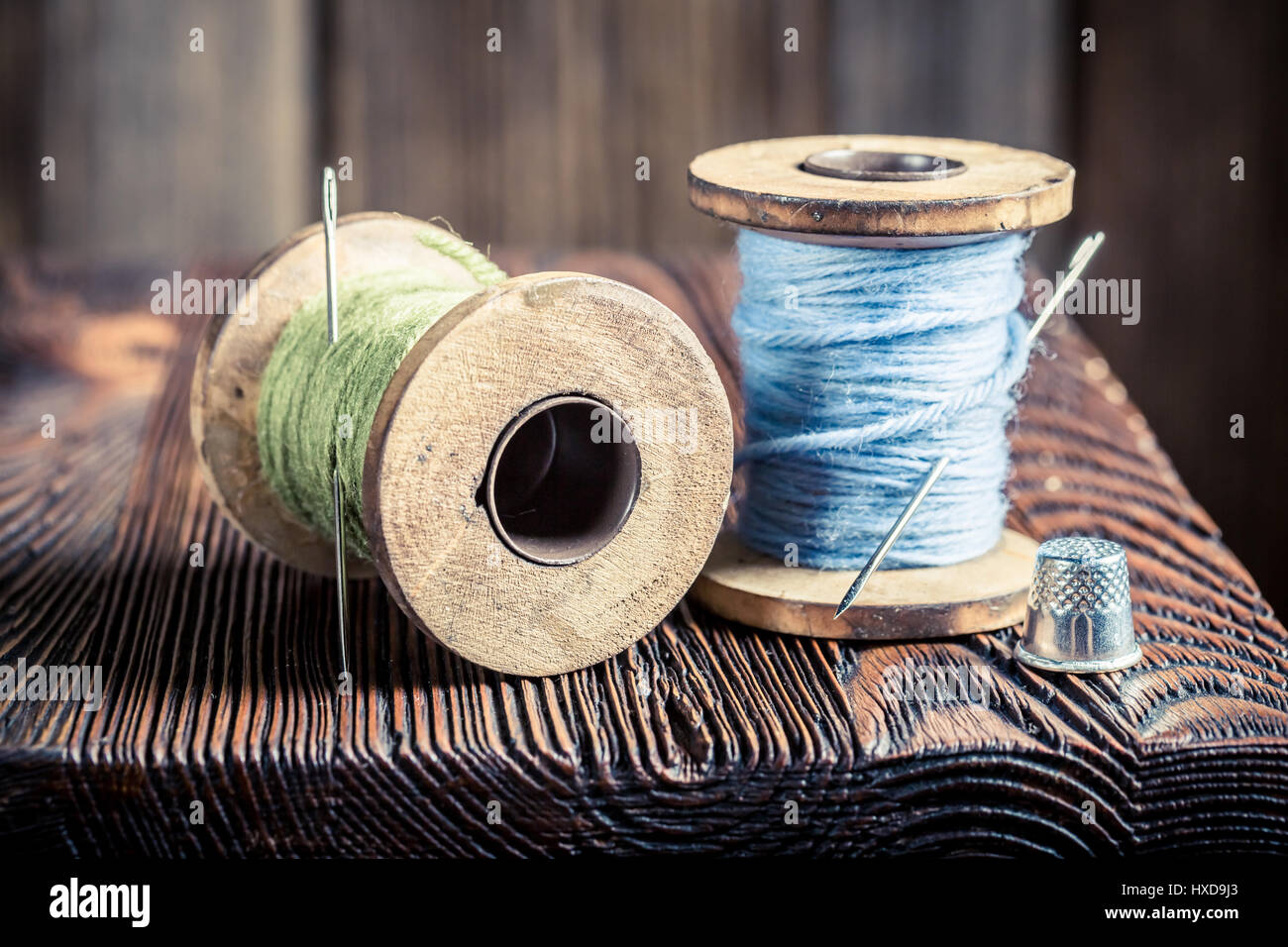 Vintage needle, threads and scissors in tailor workshop Stock Photo - Alamy