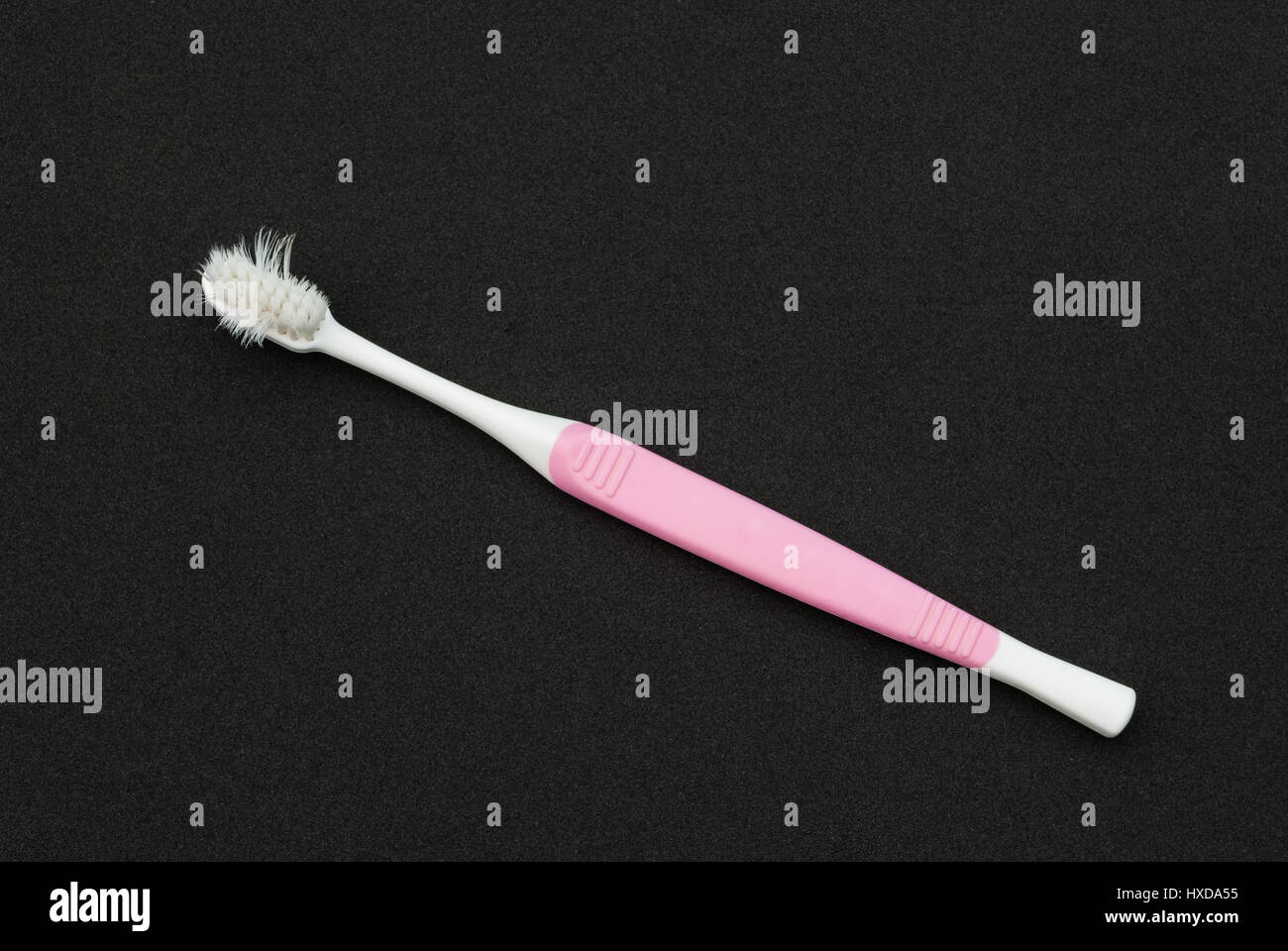 Old Used White and Pink Toothbrush in Bad Condition on Black Foam Sheet ...