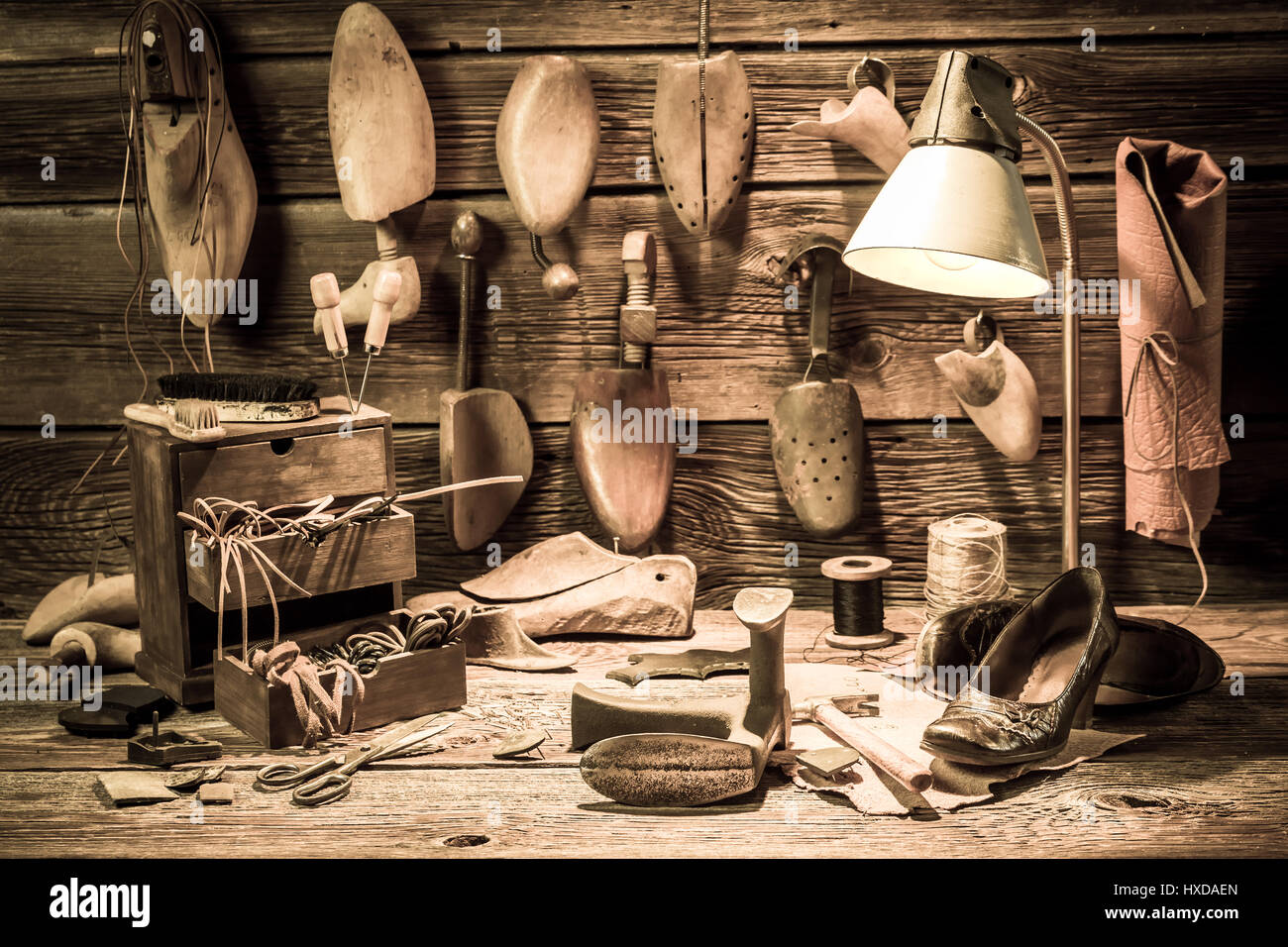 Cobbler workshop with tools, shoes and laces Stock Photo - Alamy