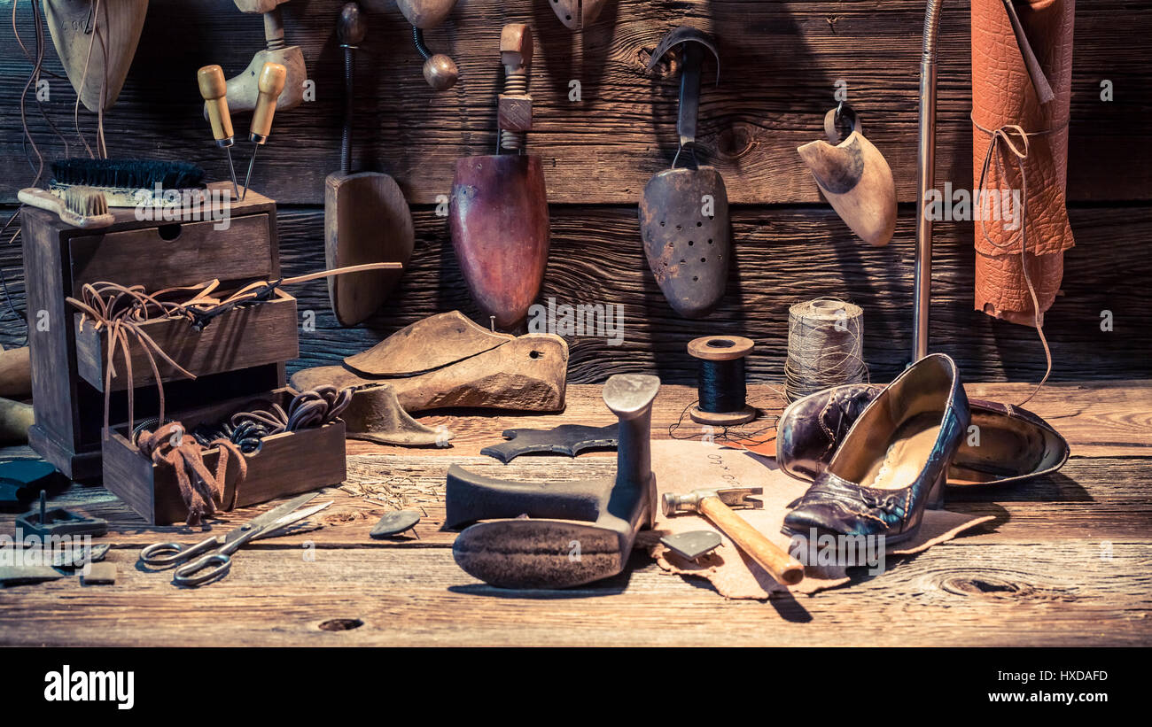 Cobbler workshop with shoes, laces and tools Stock Photo - Alamy