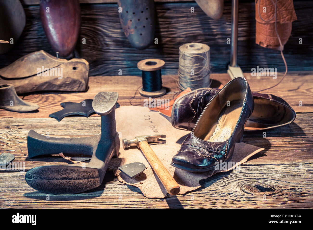Cobbler workshop with tools, leather and shoes Stock Photo - Alamy