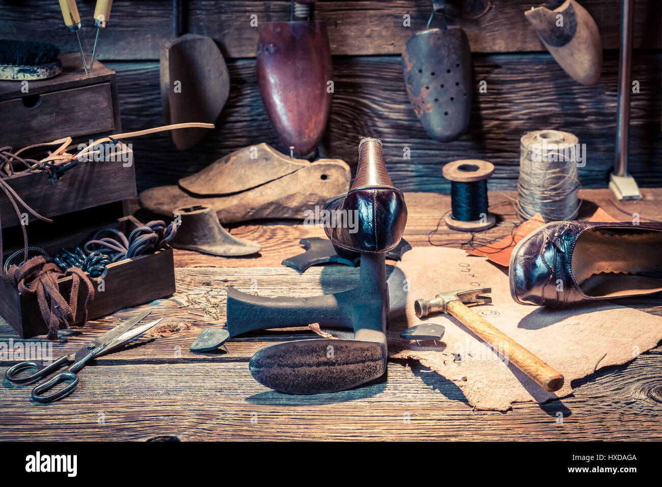 Cobbler workplace with tools, shoes and laces Stock Photo - Alamy