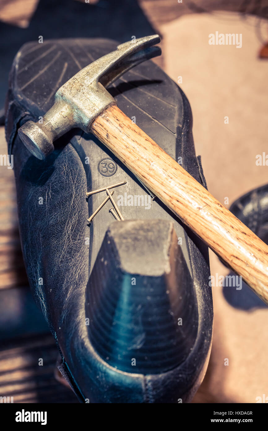 Cobbler workplace with shoes, laces and tools Stock Photo - Alamy