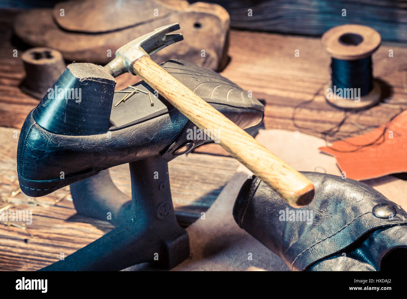 Vintage shoemaker workshop with brush and shoes Stock Photo - Alamy